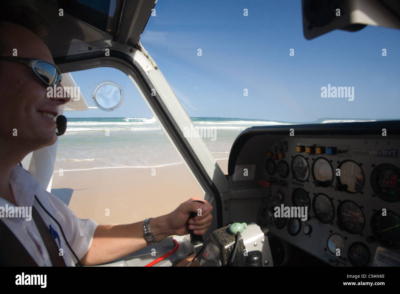 A pilot prepares for takeoff from a beach runway. Seventy-five Mile ...