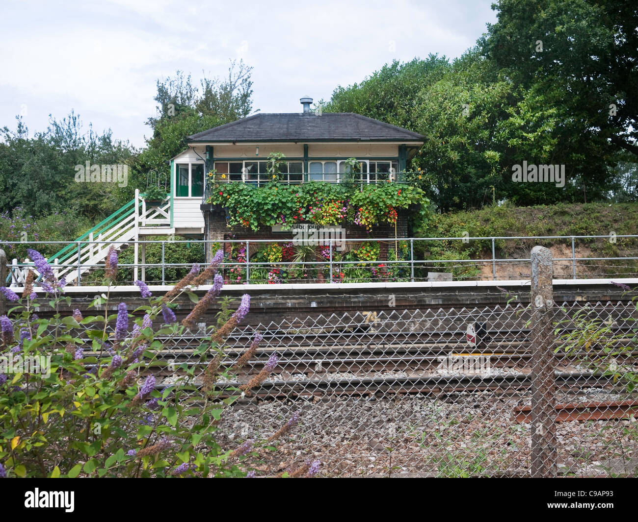 Signal box covered in flowers and hanging baskets at Pulborough station ...