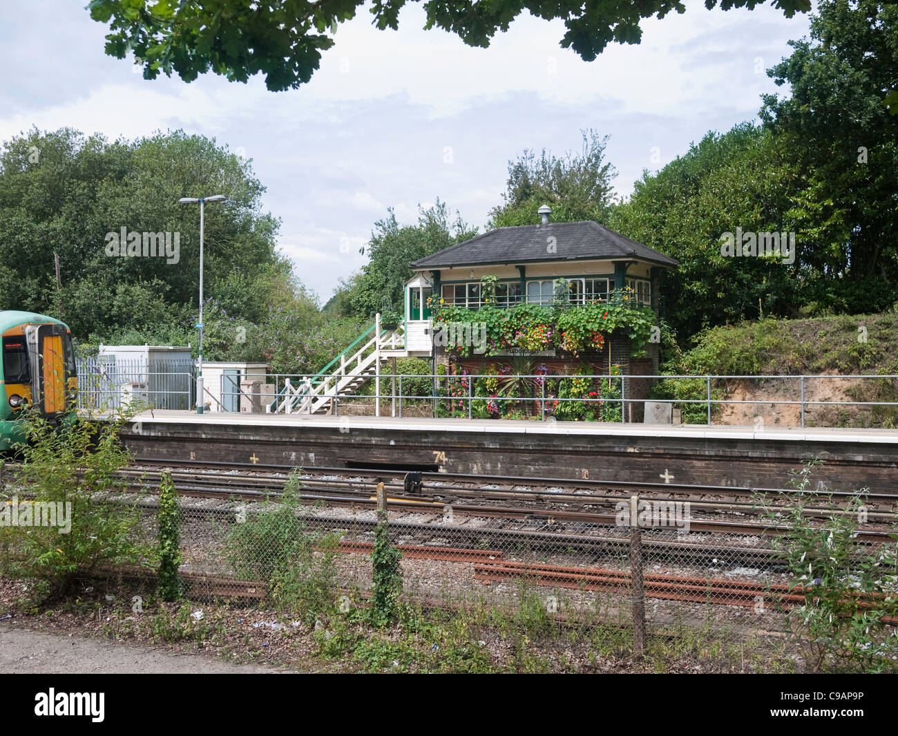 Signal box covered in flowers and hanging baskets at Pulborough station ...