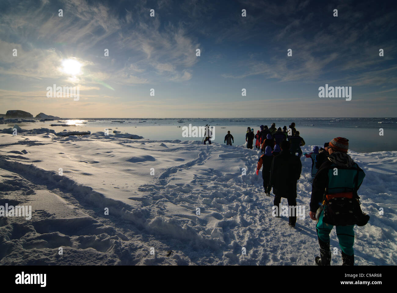 Tourists walking along frozen coastline, Shiretoko and Nemuro, Hokkaido ...