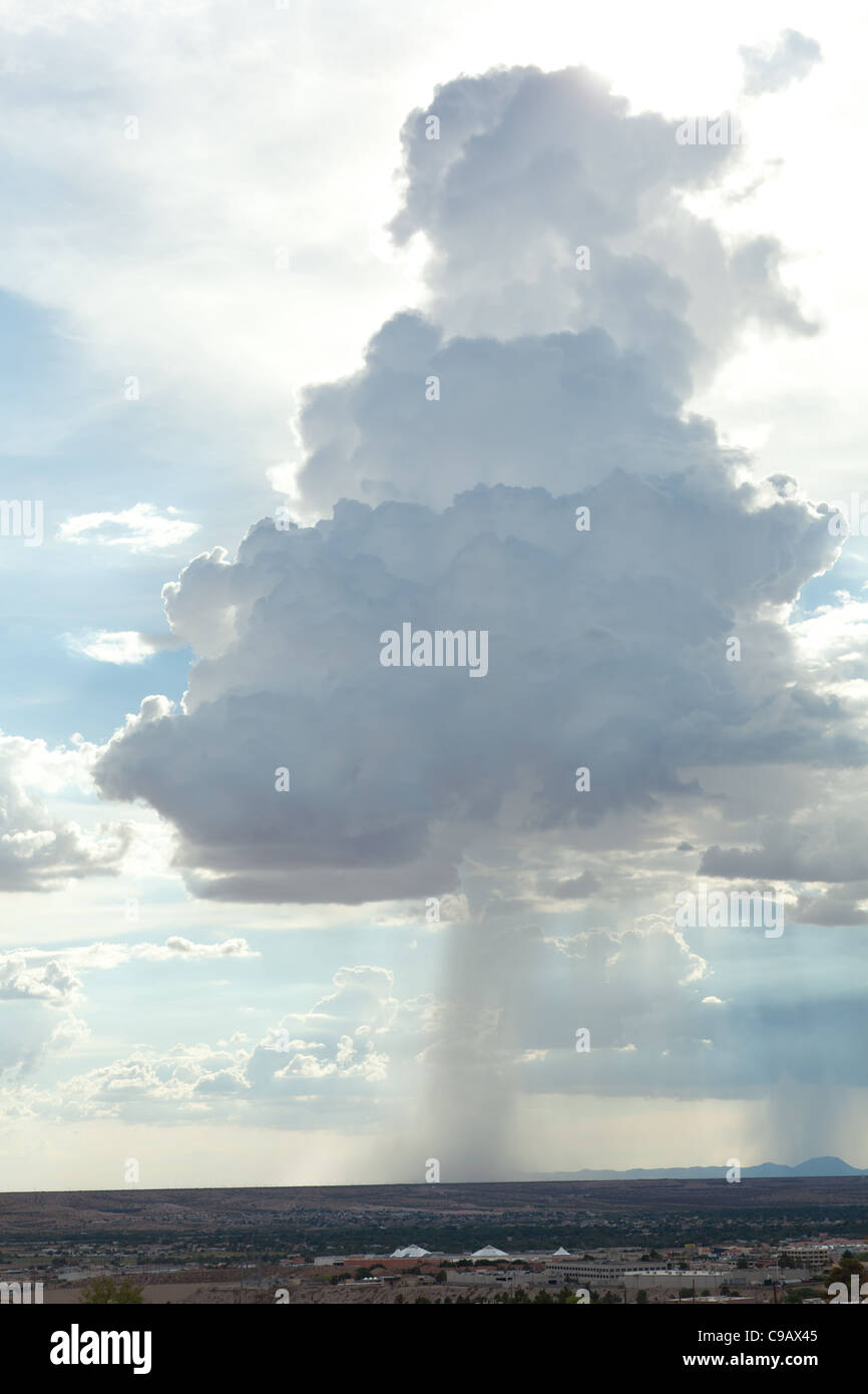Large storm cloud with column of rain and sun above Stock Photo - Alamy