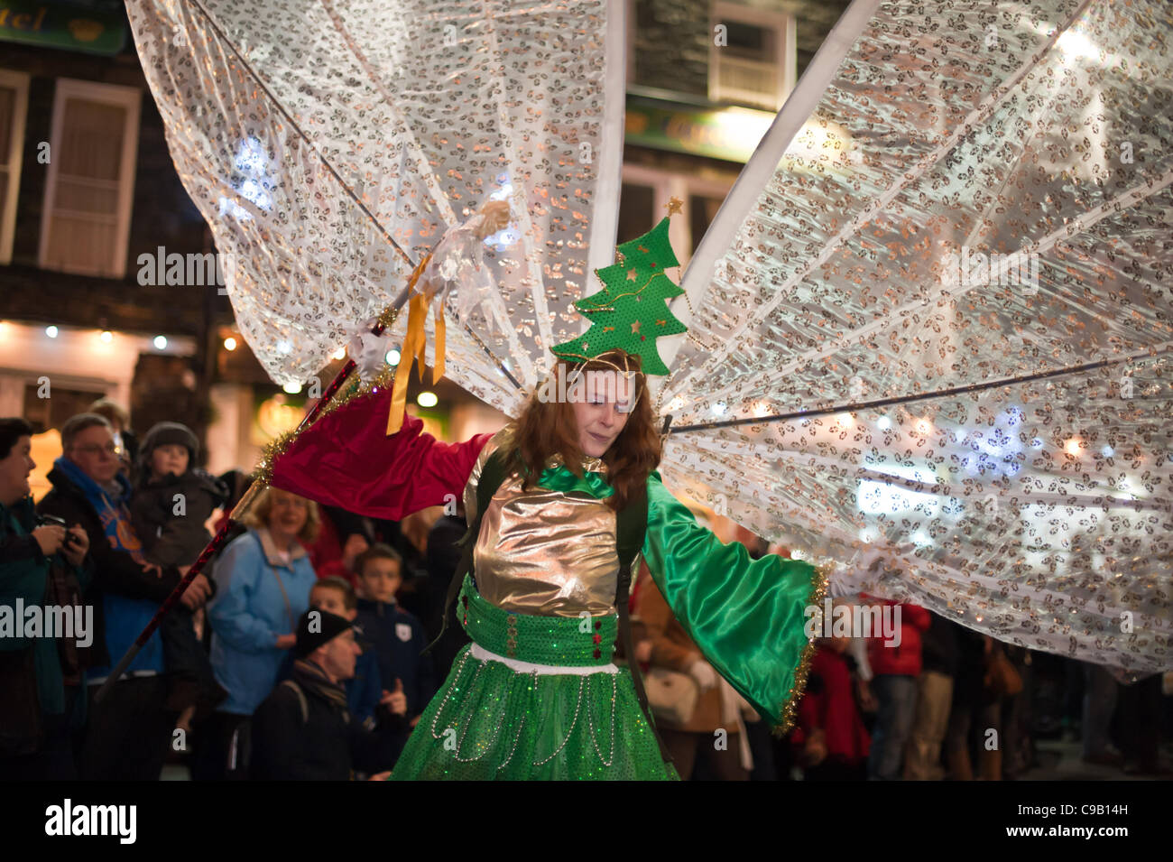 A dancer leads a procession as Christmas celebrations get underway at ...