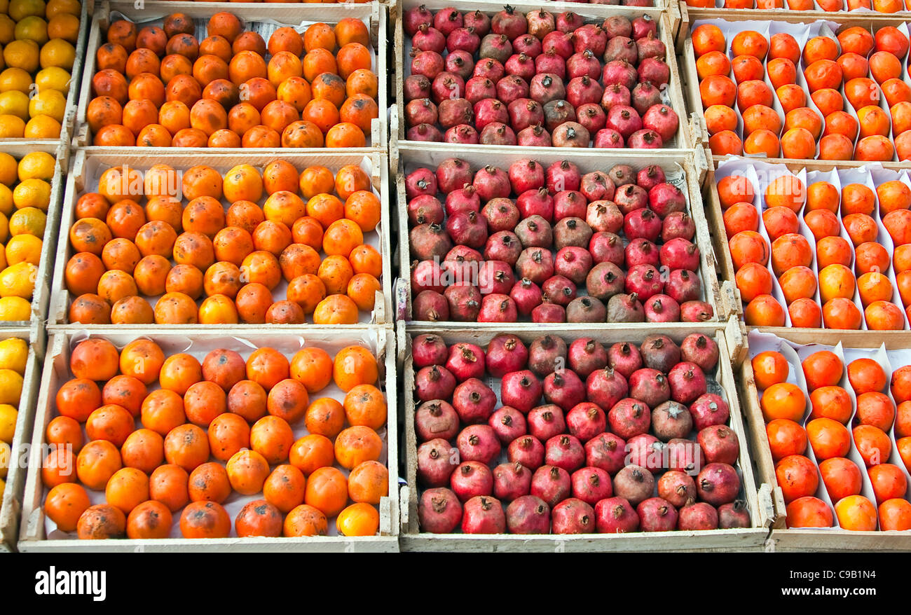 Persimmons and pomegranates in boxes Stock Photo - Alamy