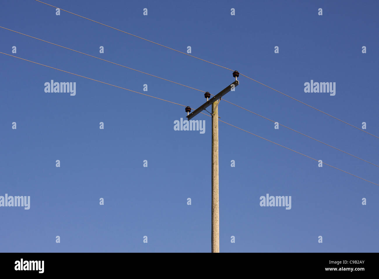 Telegraph pole and cables against deep blue sky Stock Photo - Alamy
