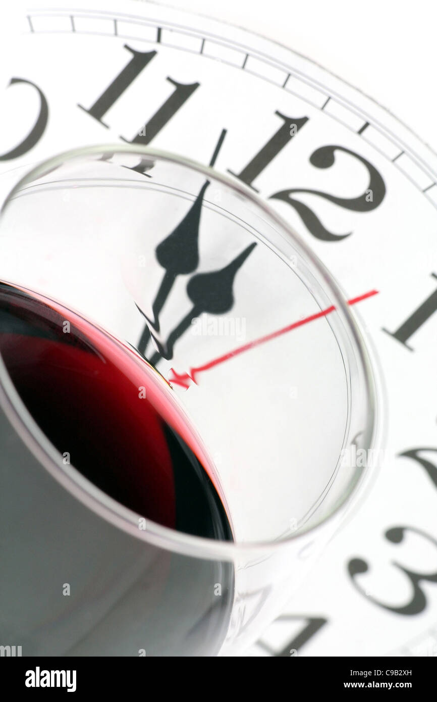 red wine, wine glass and clock with white background, concept of party ...