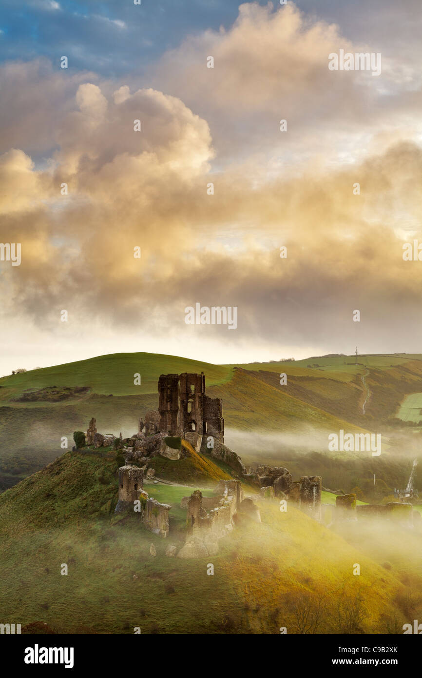 Corfe castle rising through the early morning mist Stock Photo - Alamy