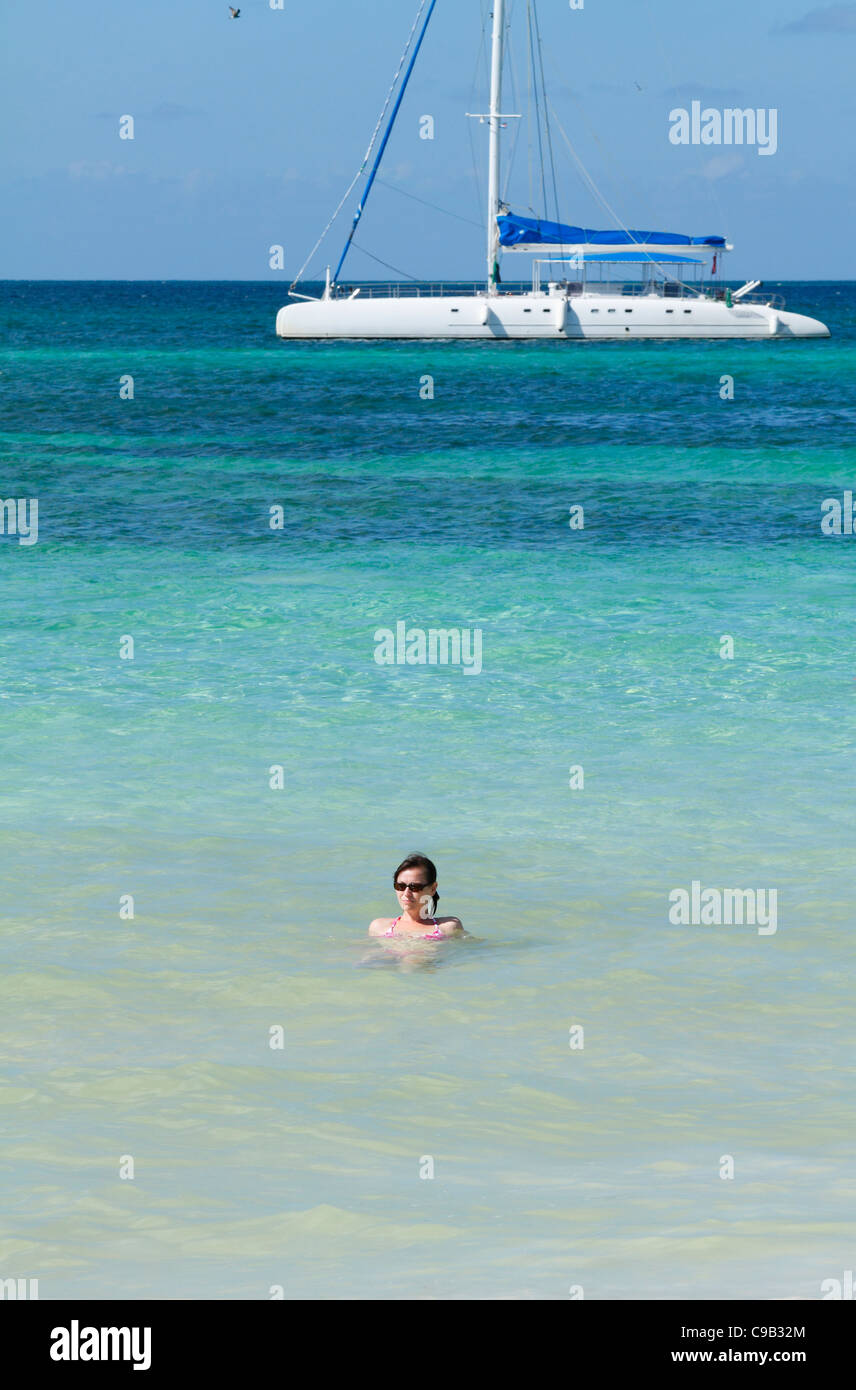 Adult woman swimming in the turquoise Caribbean sea at Guardalavaca ...