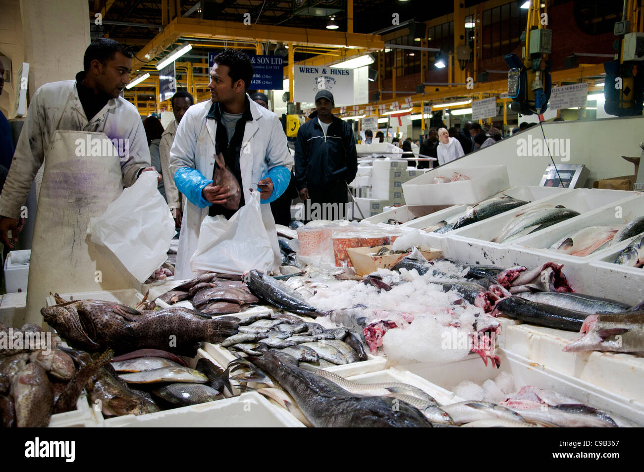 Billingsgate Fish Market in London. Workers sell their fresh fish to ...