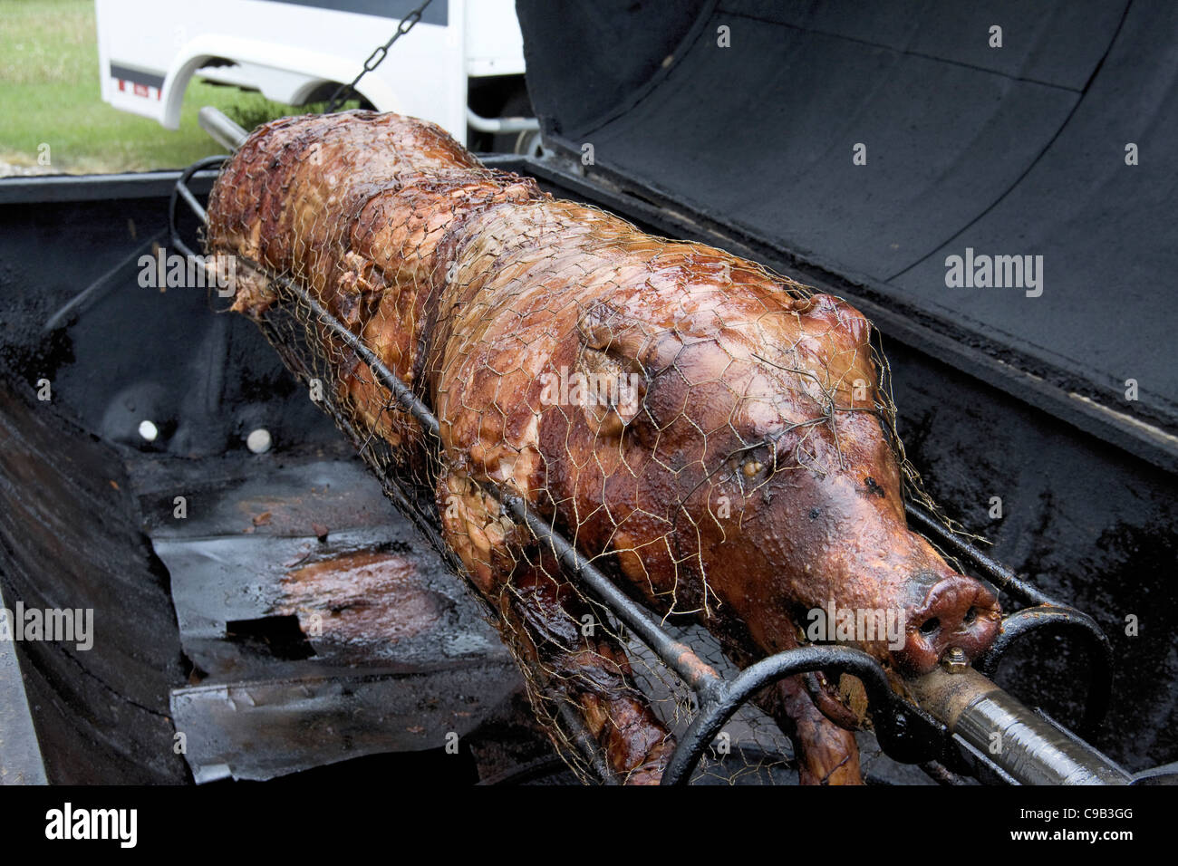 A whole pig roasting in a home made barbecue Stock Photo - Alamy