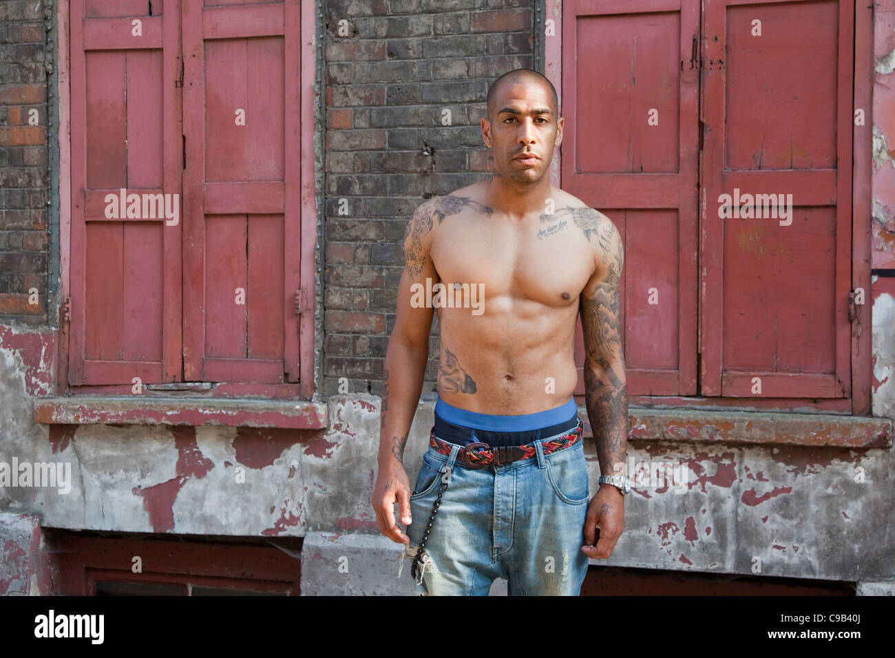 Young mixed-race British man with tattoos Stock Photo - Alamy