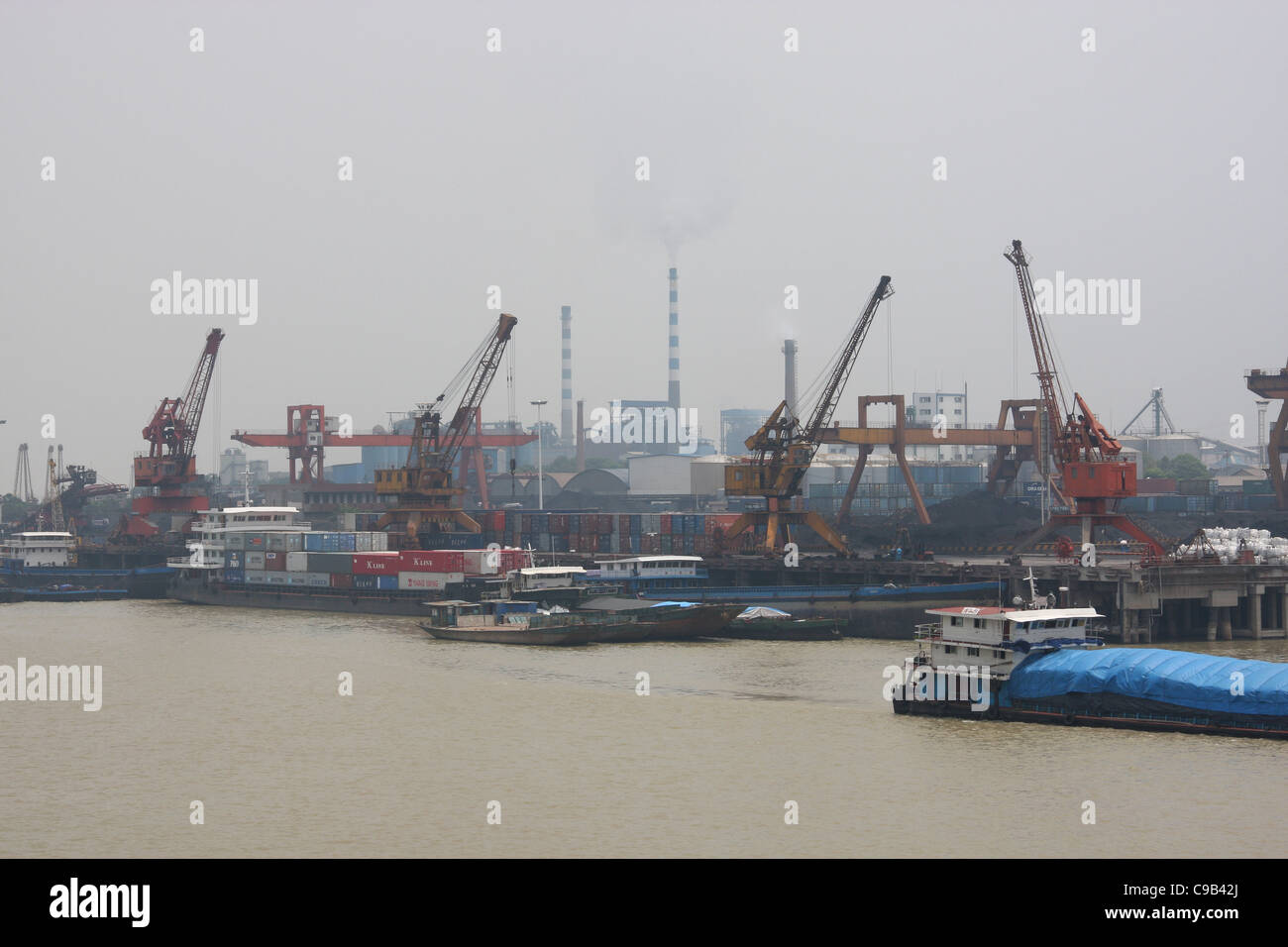 Gantry cranes, container dock, freighters and industry at Yueyang ...