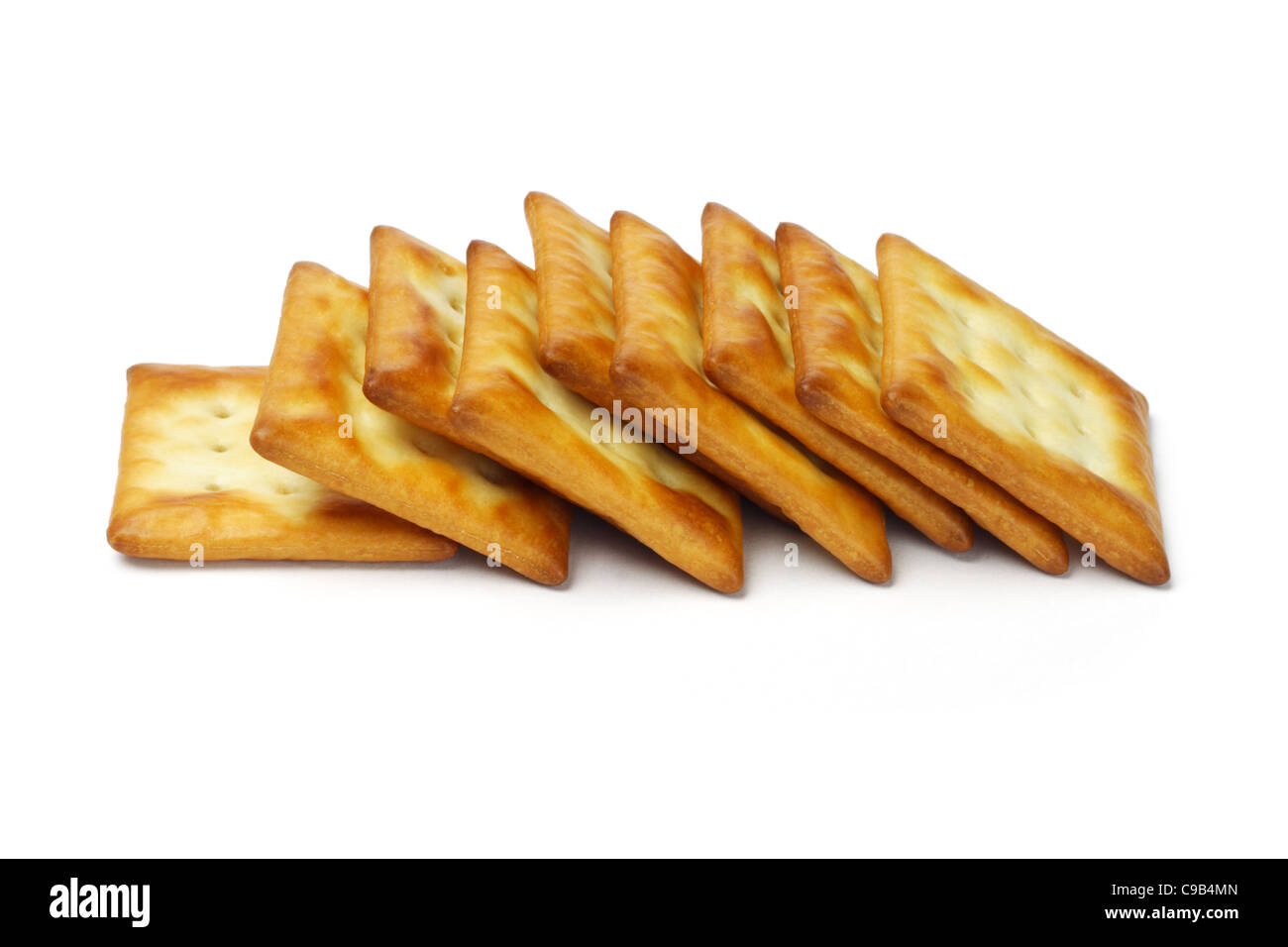 Row of square crackers lying on white background Stock Photo - Alamy