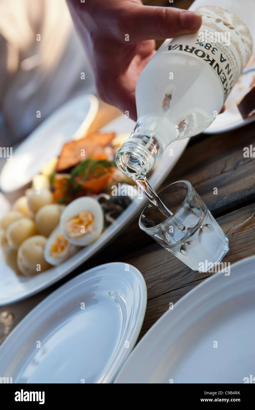 Pouring a glass of Koskenkorva Viina (also known simply as Koskenkorva ...