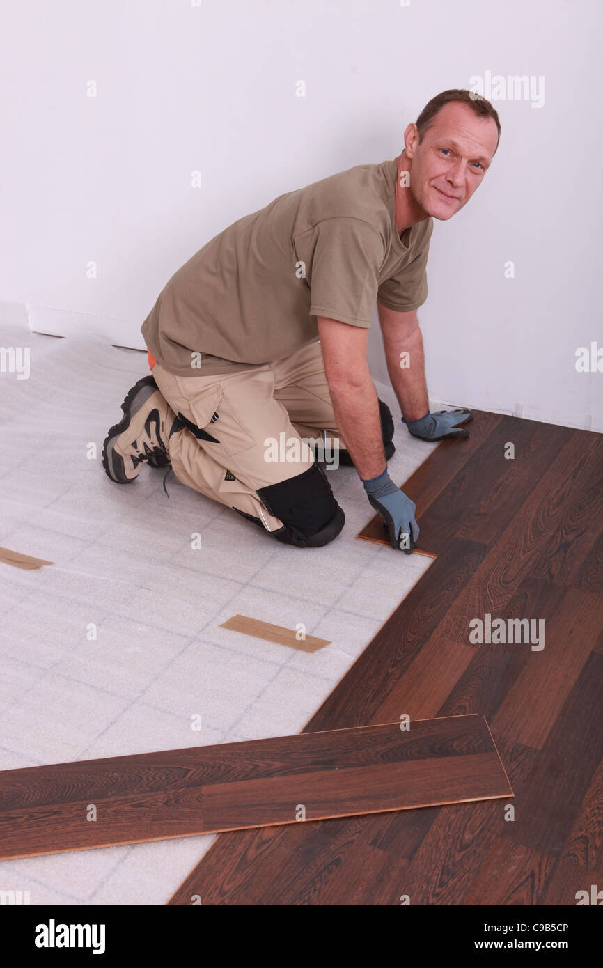 Man laying wooden flooring Stock Photo - Alamy