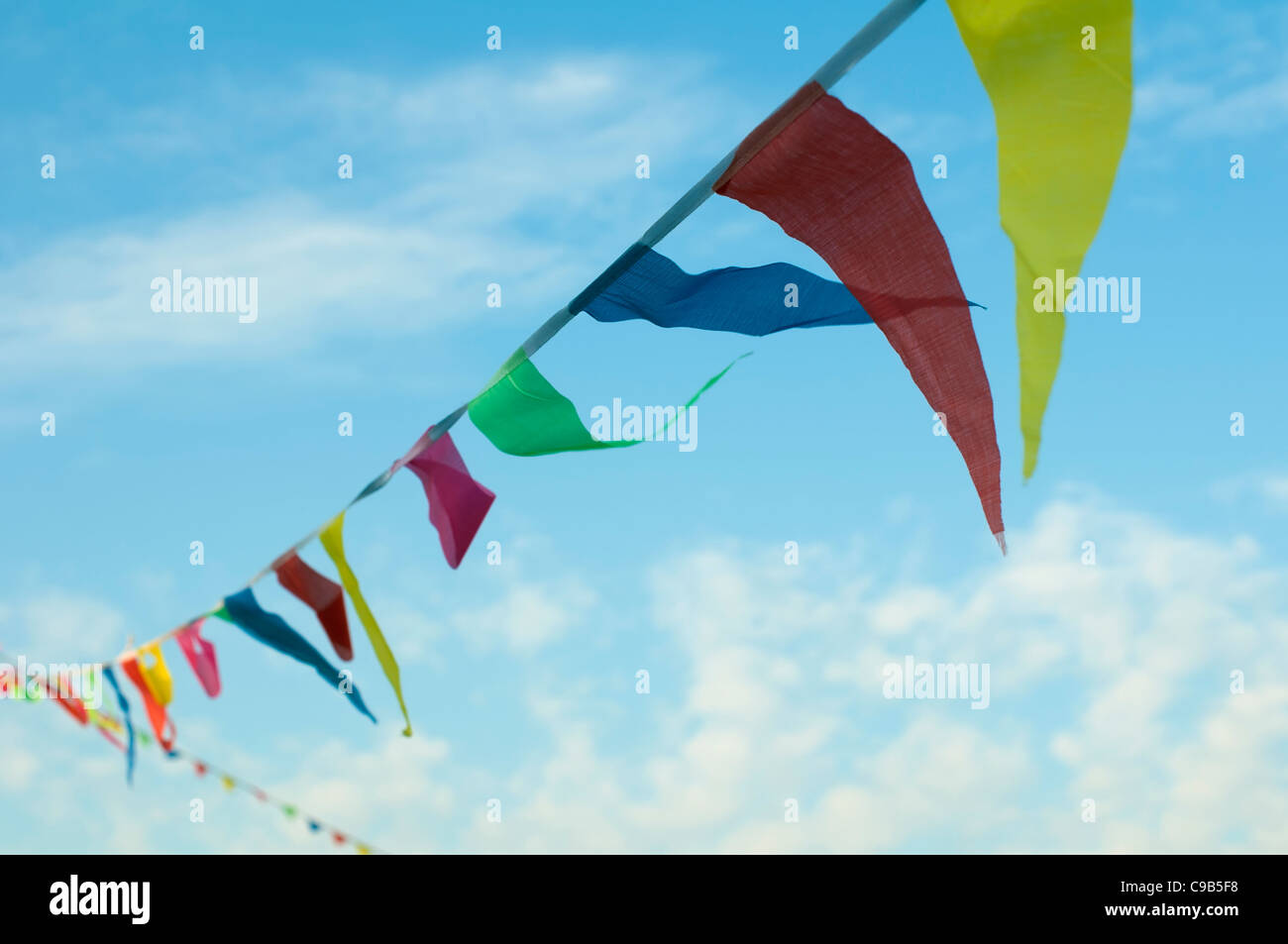 Multicolored striped triangular flags on a rope Stock Photo - Alamy
