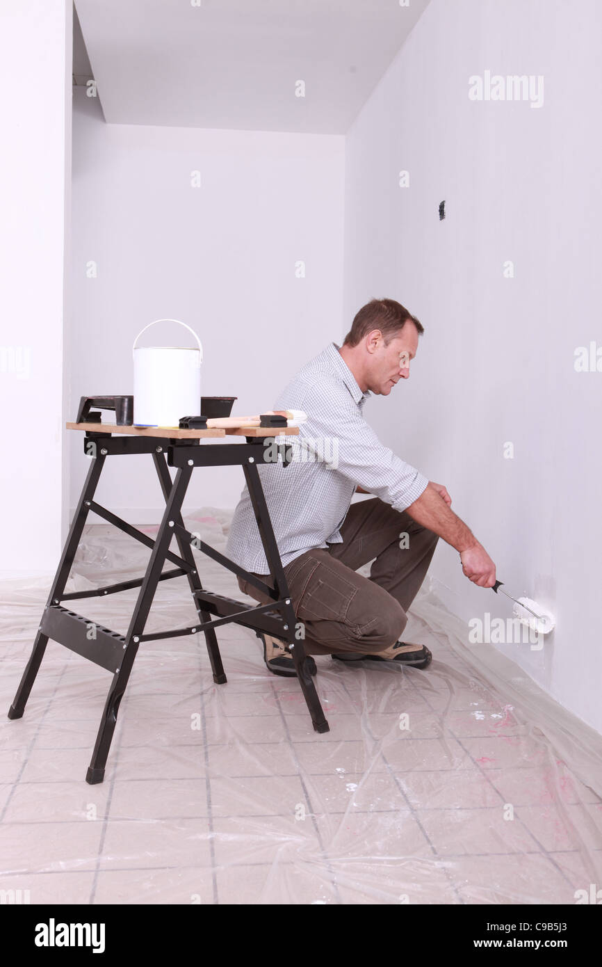 Man painting a wall Stock Photo - Alamy