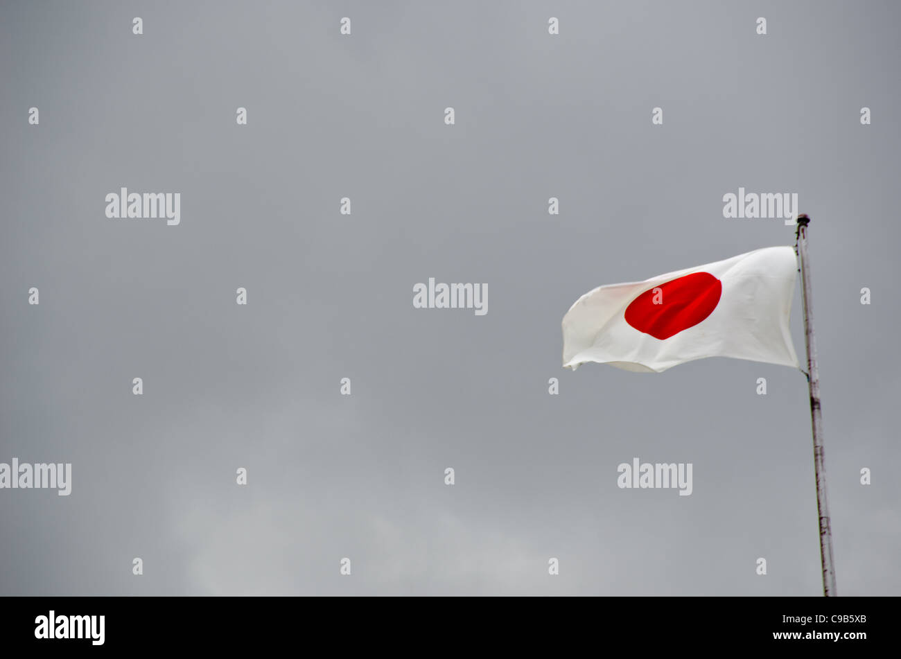 Japanese flag on flag pole in wind Stock Photo - Alamy