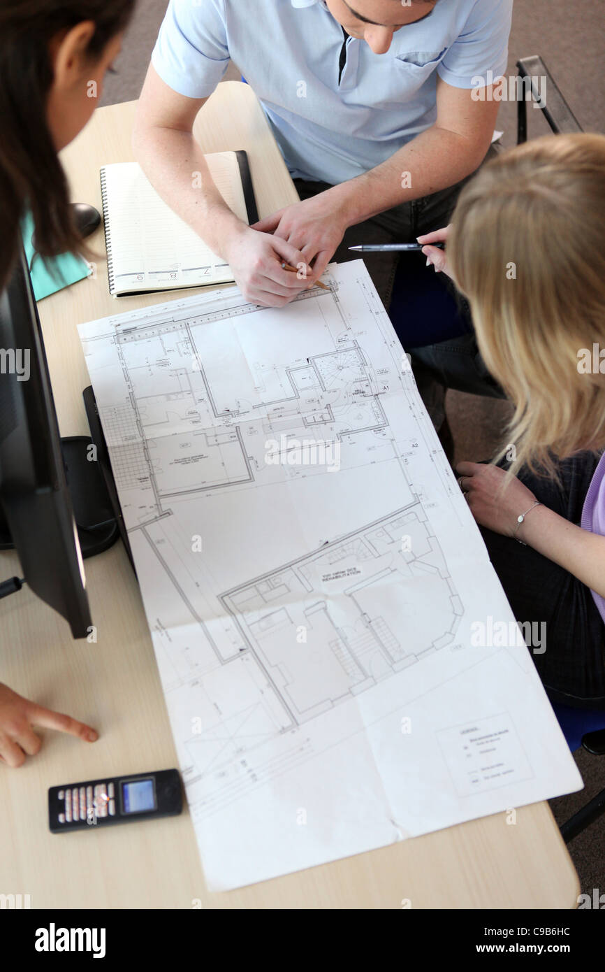 People looking at the layout of a house Stock Photo - Alamy