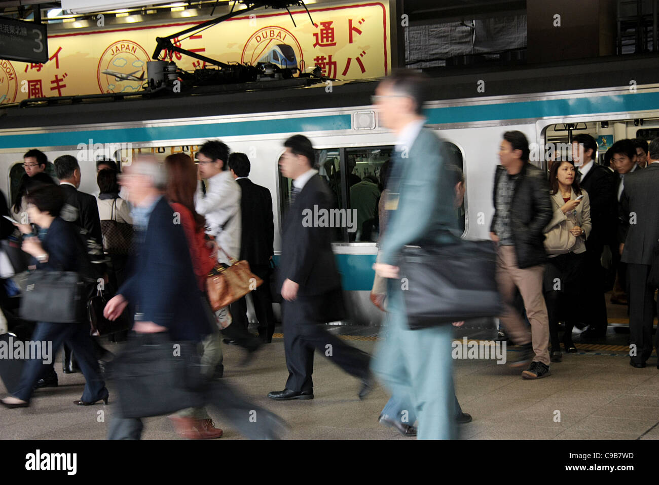 Commuters leaving and entering the train at a busy underground metro ...