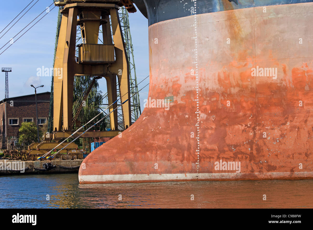 Shipyard industrial scenery, bow of a large cargo ship docked at ...