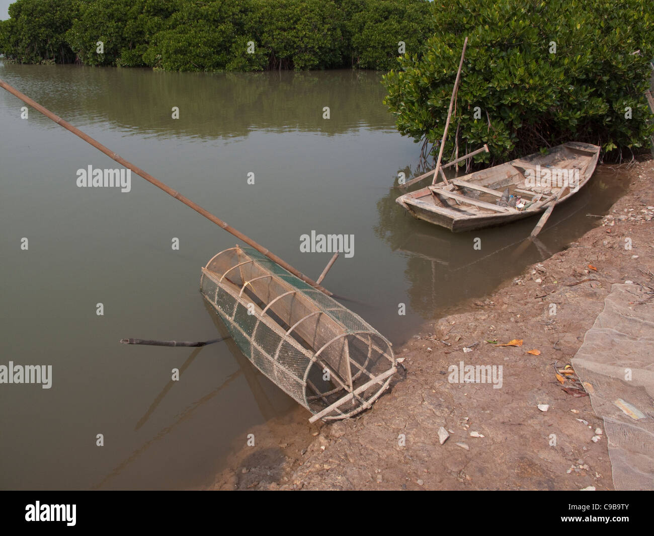 Small fishing boat and trap net, Halong Bay, Vietnam Stock Photo - Alamy