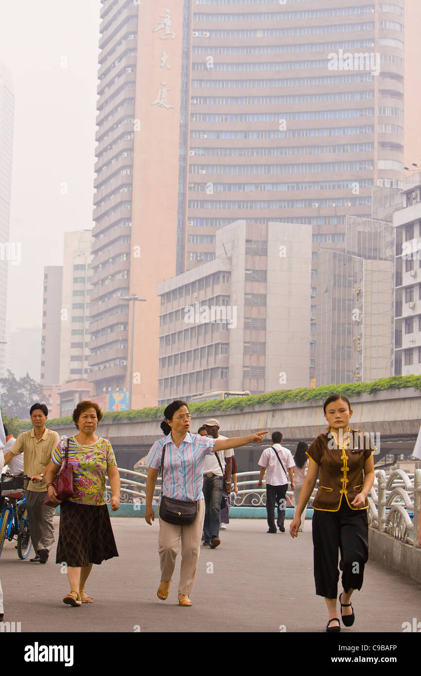 GUANGZHOU, GUANGDONG PROVINCE, CHINA - People on pedestrian bridge, and ...