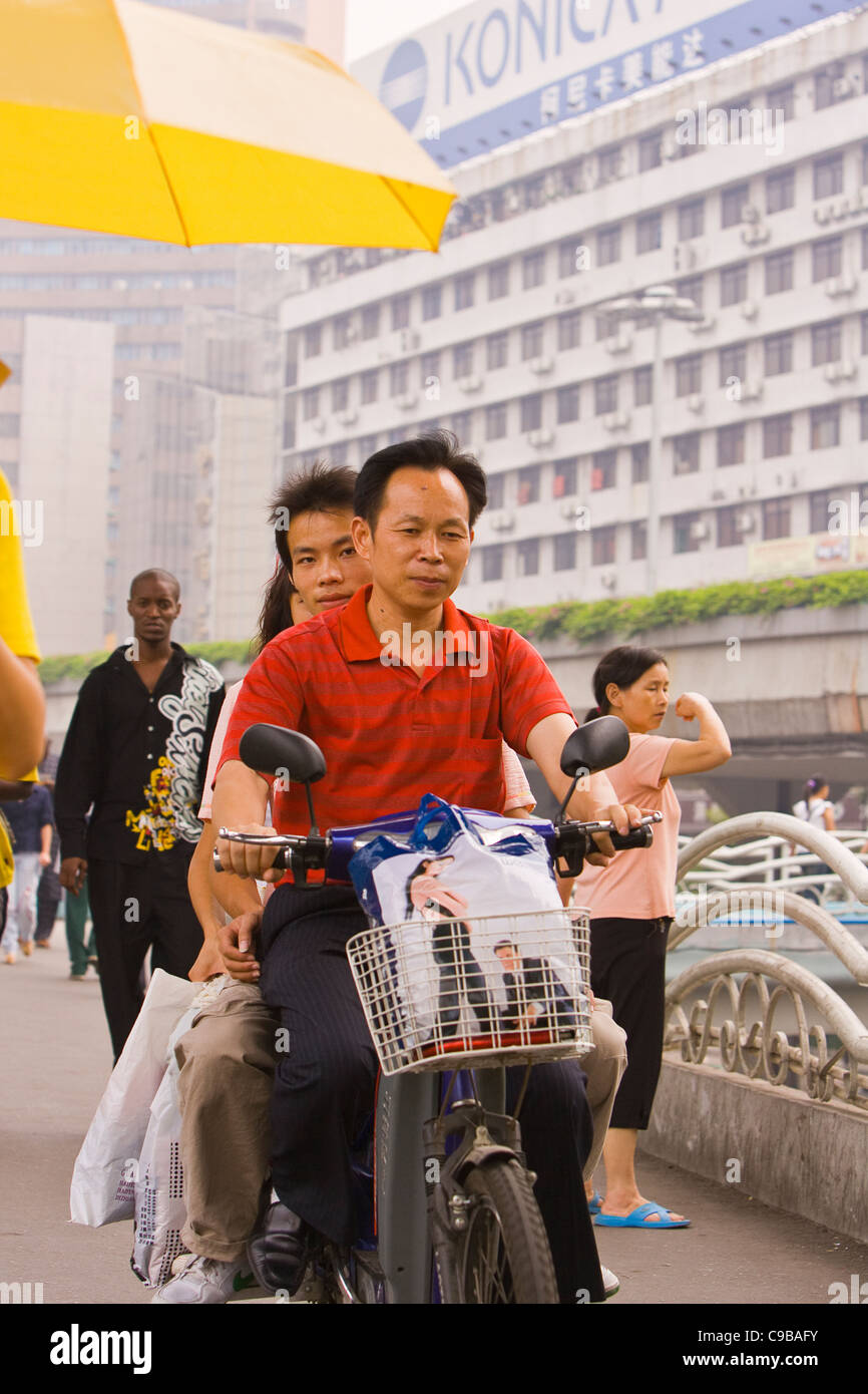 GUANGZHOU, GUANGDONG PROVINCE, CHINA - People on pedestrian bridge, and ...