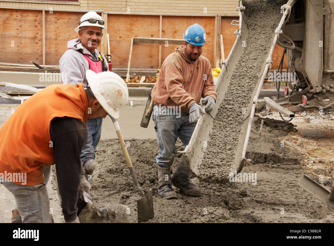 Construction workers pour concrete during Marion Street reconstruction ...