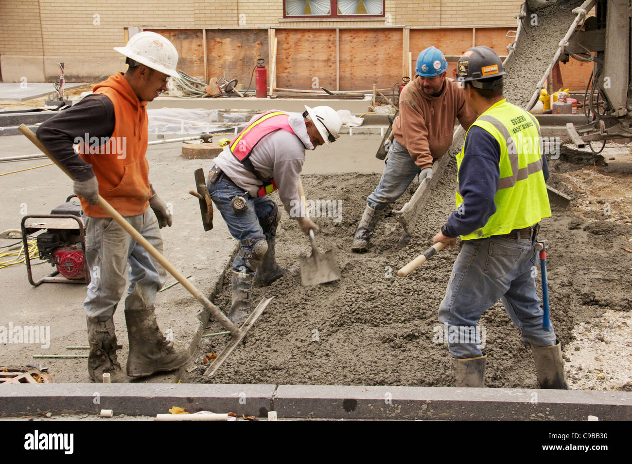 Construction workers pour concrete during Marion Street reconstruction ...