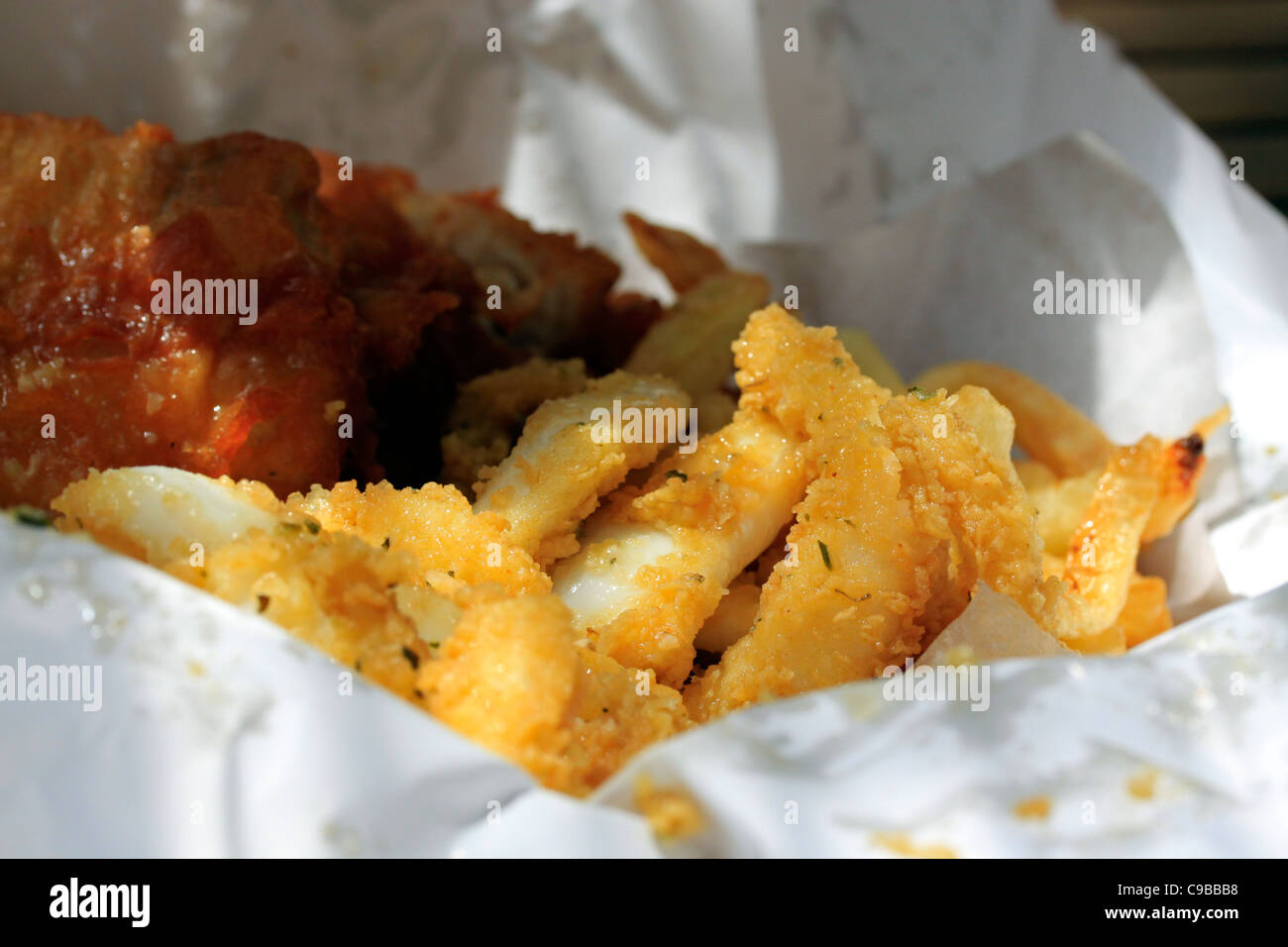 Fish, chips and calamari in paper wrapping from restaurant at Kalk Bay ...