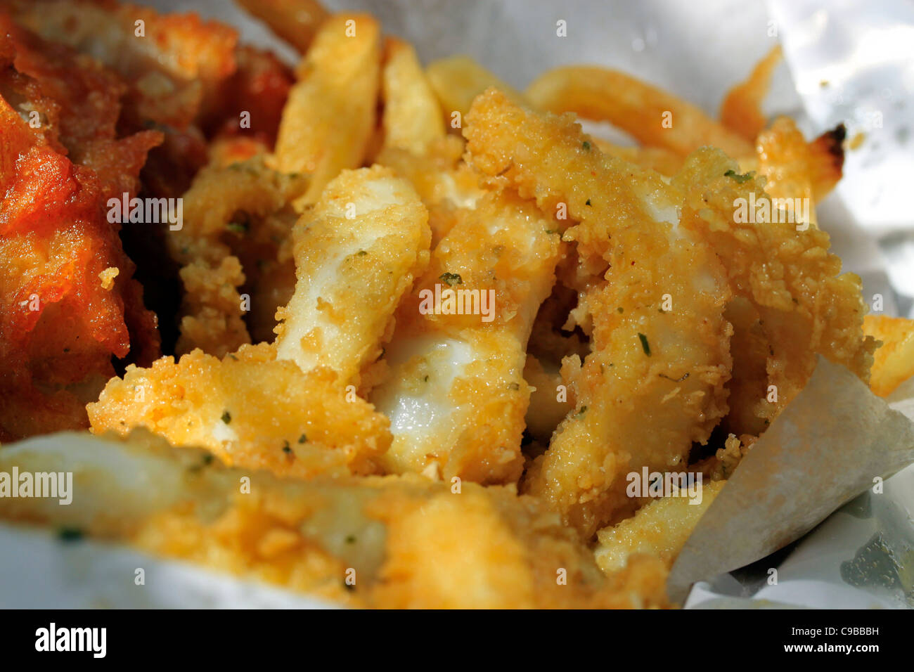 Fish, chips and calamari in paper wrapping from restaurant at Kalk Bay ...