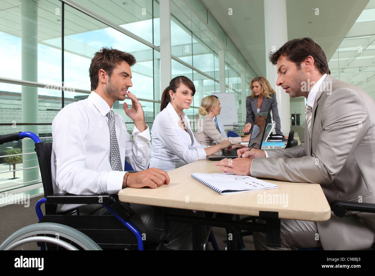 Man in wheelchair working in an office Stock Photo - Alamy