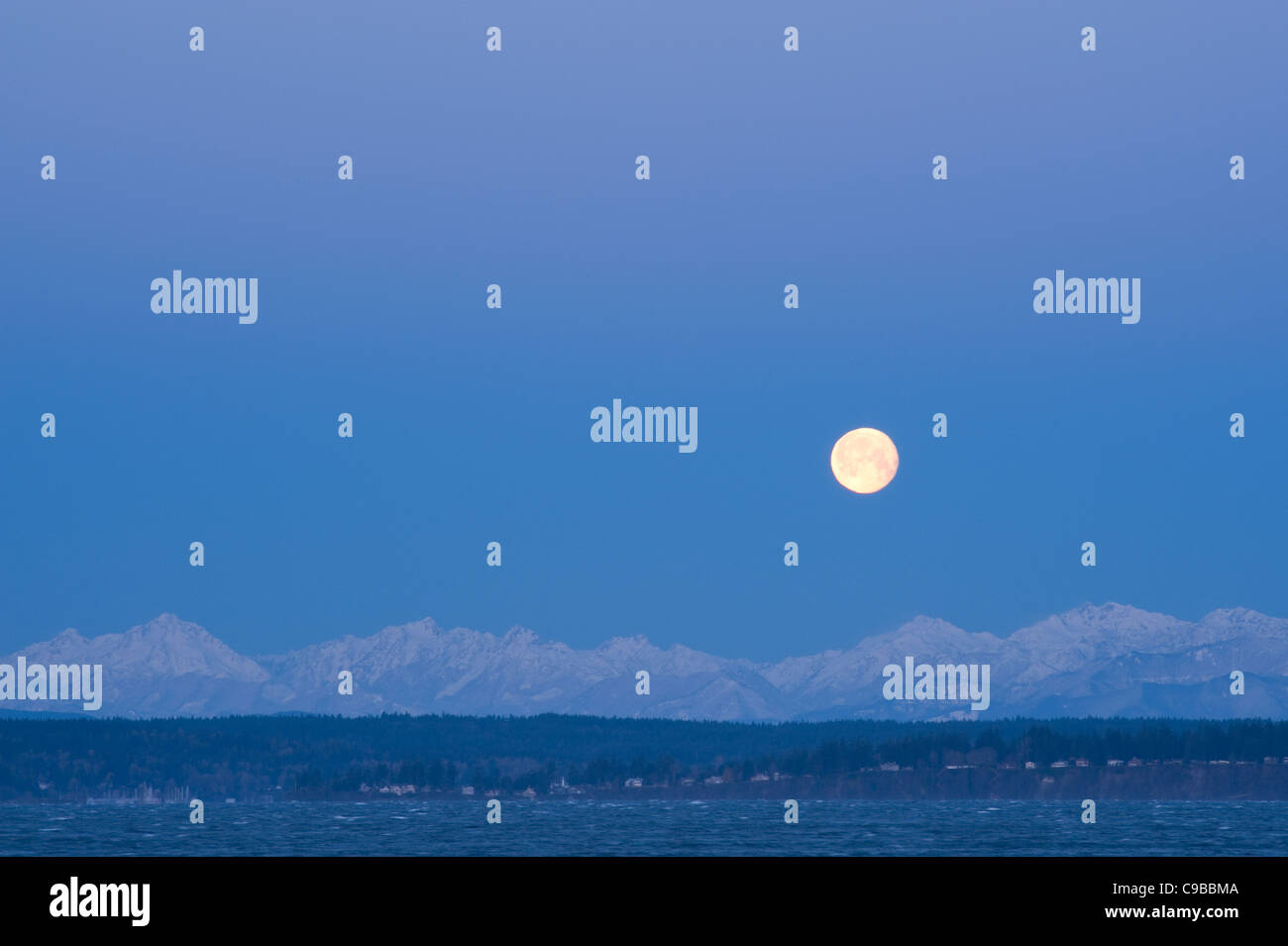 Sunrise with moon set over snow covered Olympic Mountains with Elliott ...