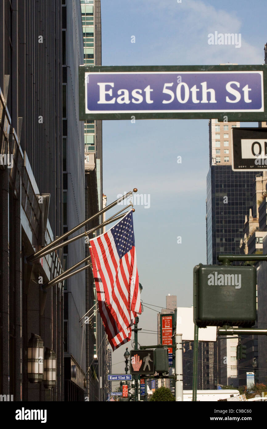 East 50th street sign and the American flag flying in New York City ...