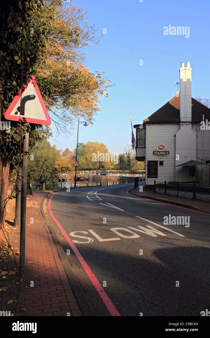 Slow sign on road at Carshalton Ponds, Sutton South London England UK ...