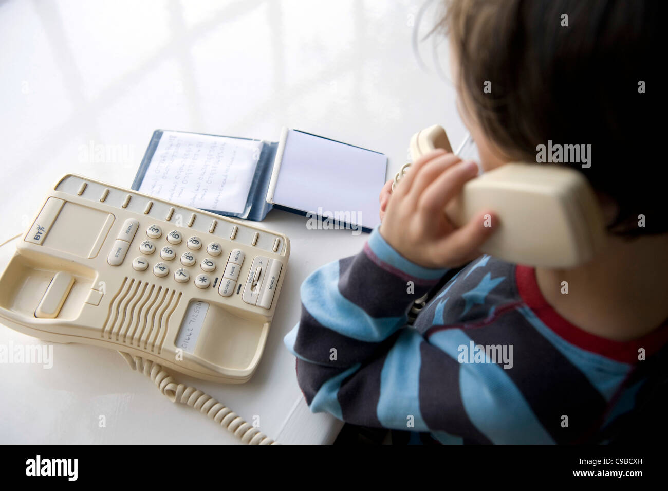 6 year old english boy using a landline phone at his grandparents home ...