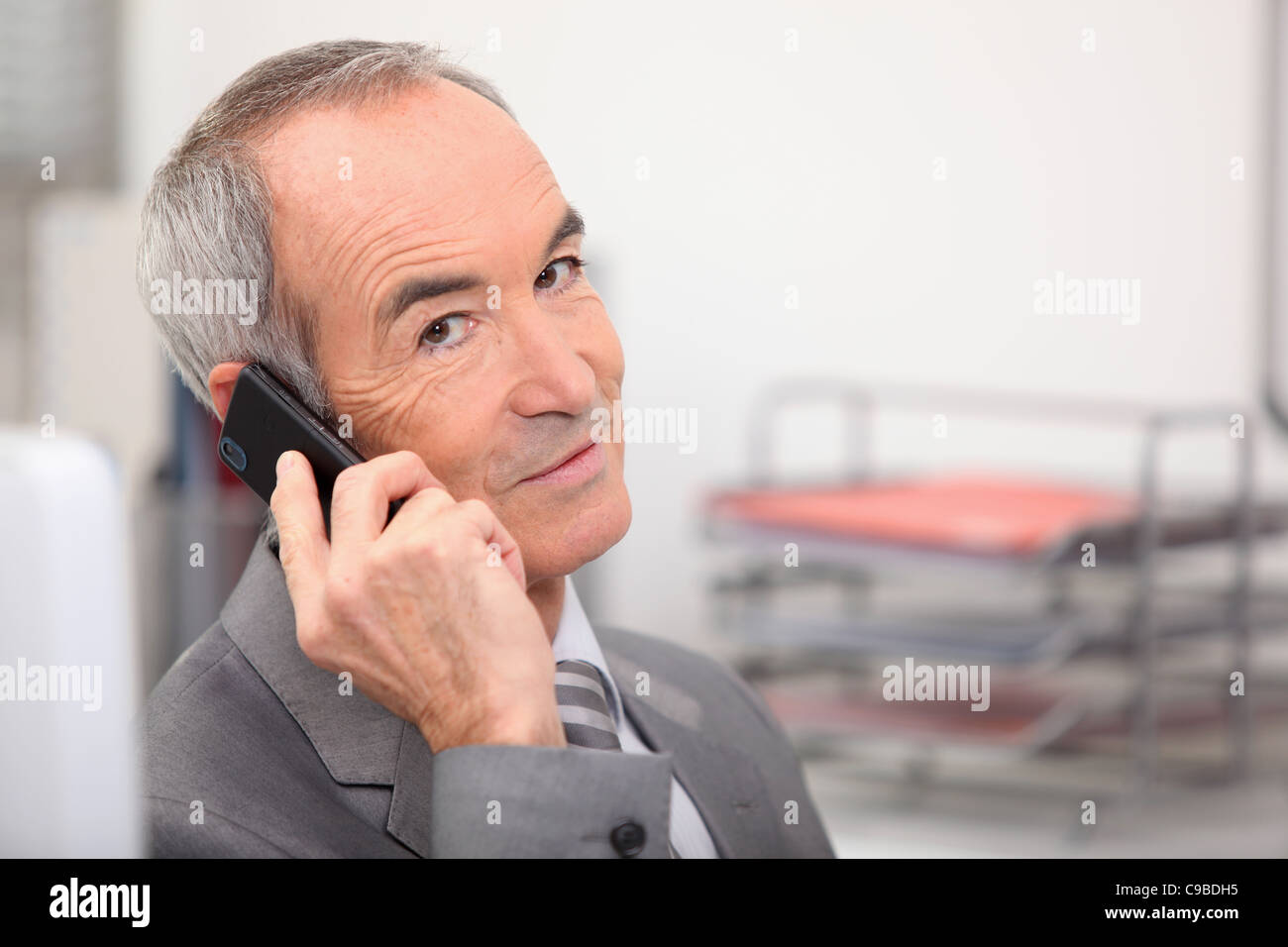 Admin worker with mobile telephone Stock Photo - Alamy