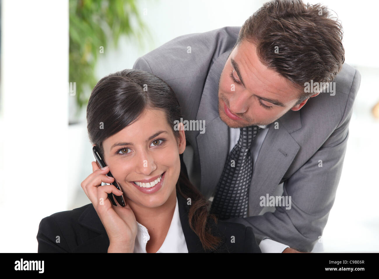 Man flirting with his colleague Stock Photo - Alamy