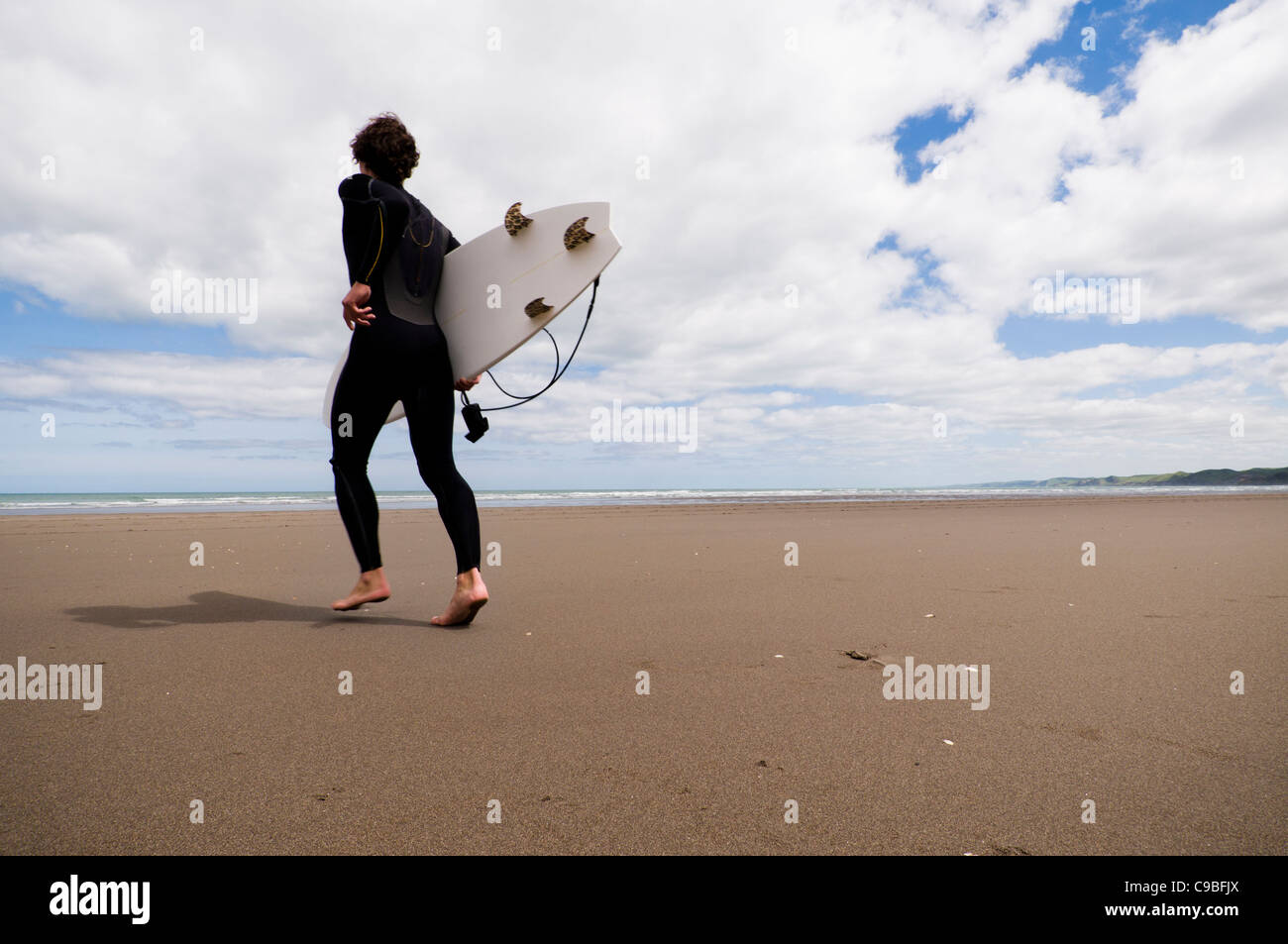Run into ocean beach wetsuit hi-res stock photography and images - Alamy