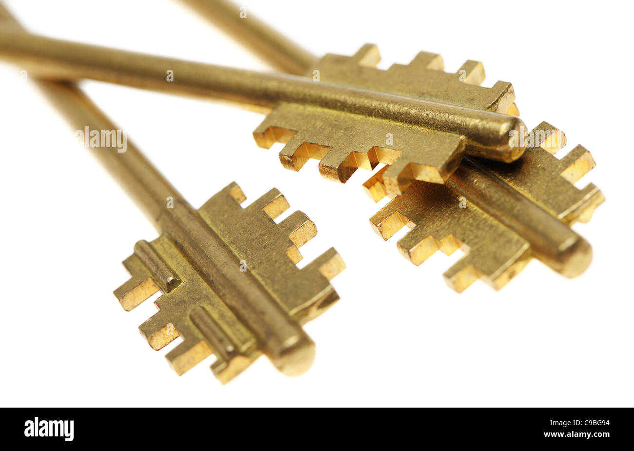 Three gold keys. It is isolated on a white background Stock Photo - Alamy