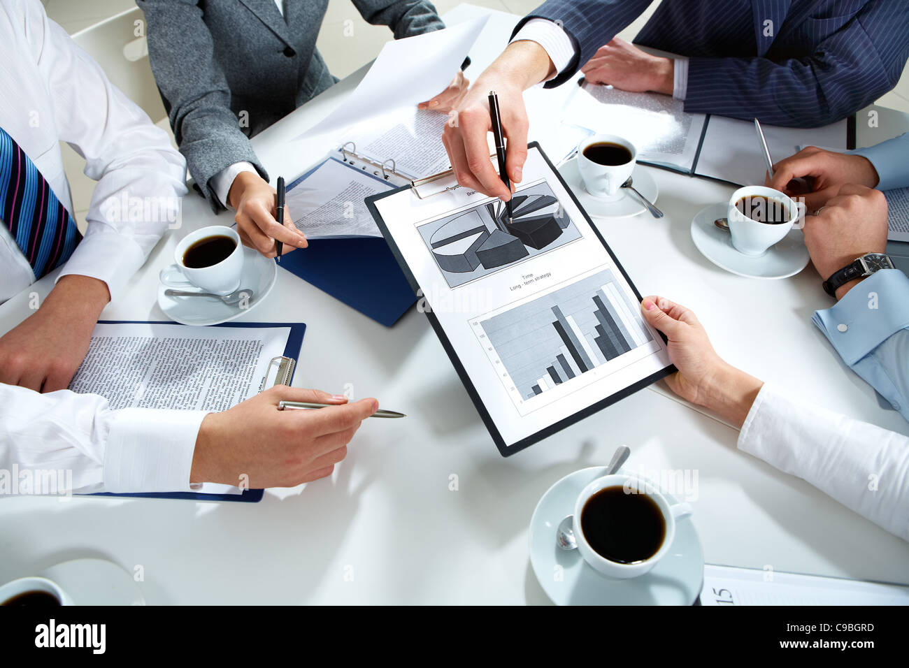 Image of human hands during discussion of business plan Stock Photo - Alamy
