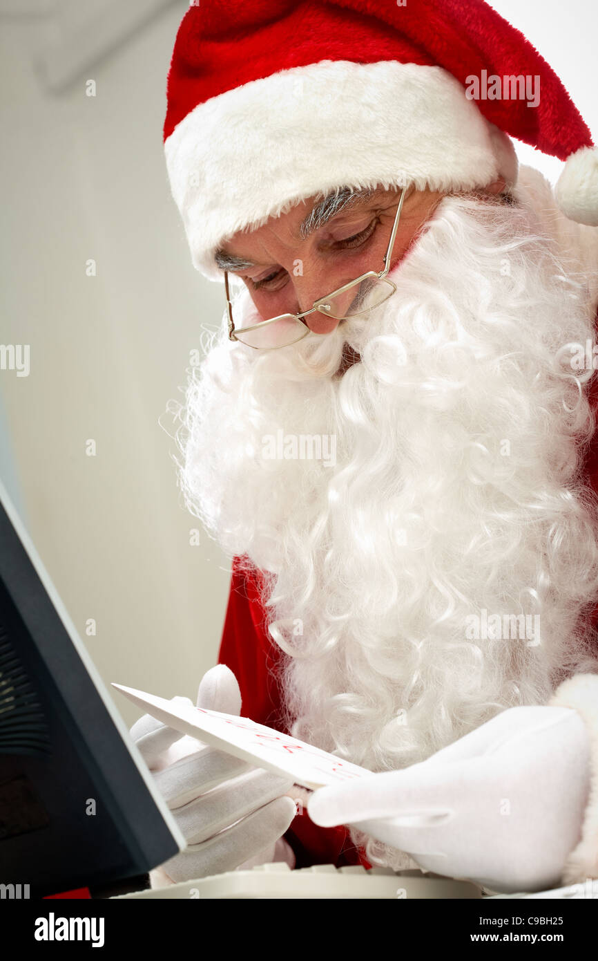 Santa holding Christmas letter and looking at it Stock Photo - Alamy