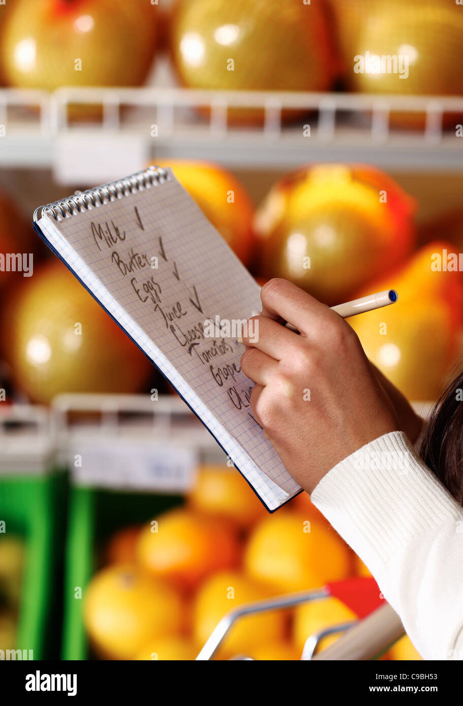 Image of female hands with pen holding product list while buying goods ...