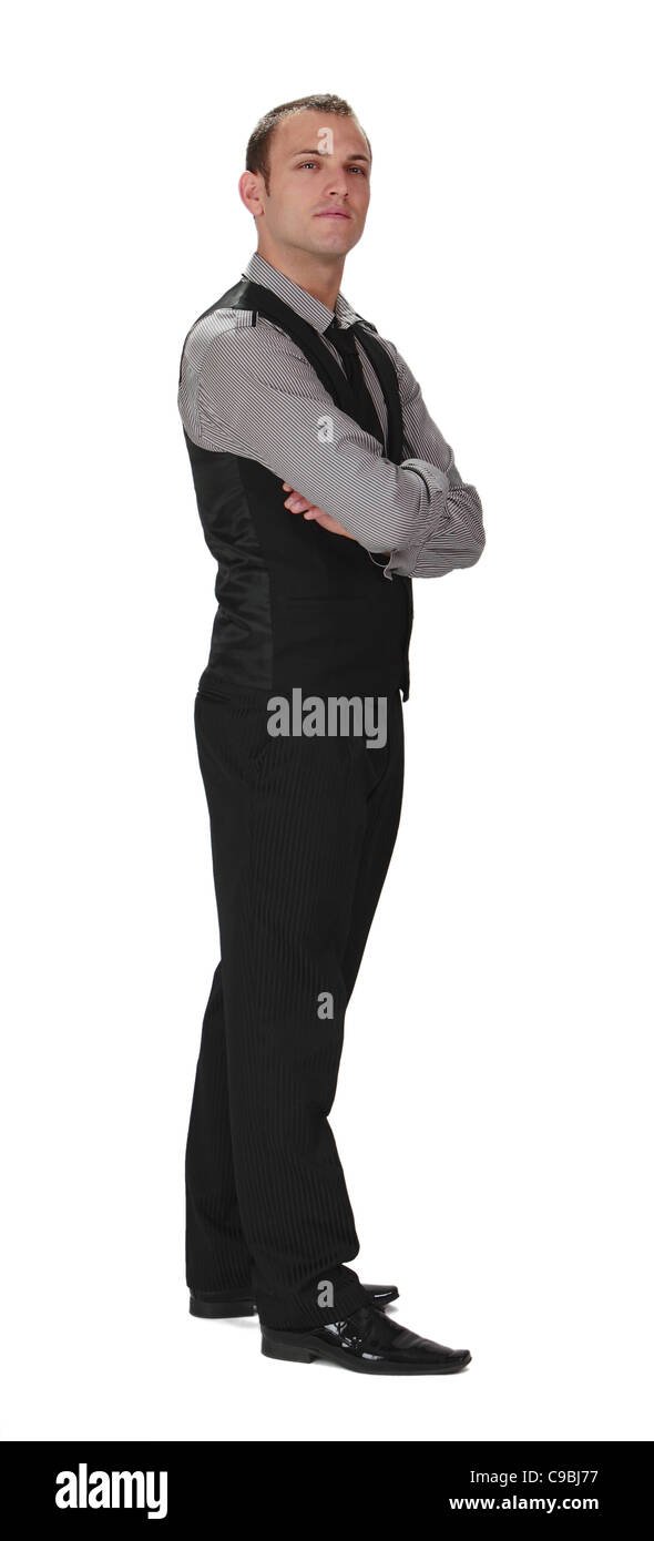 Young confident businessman standing up against a white background ...