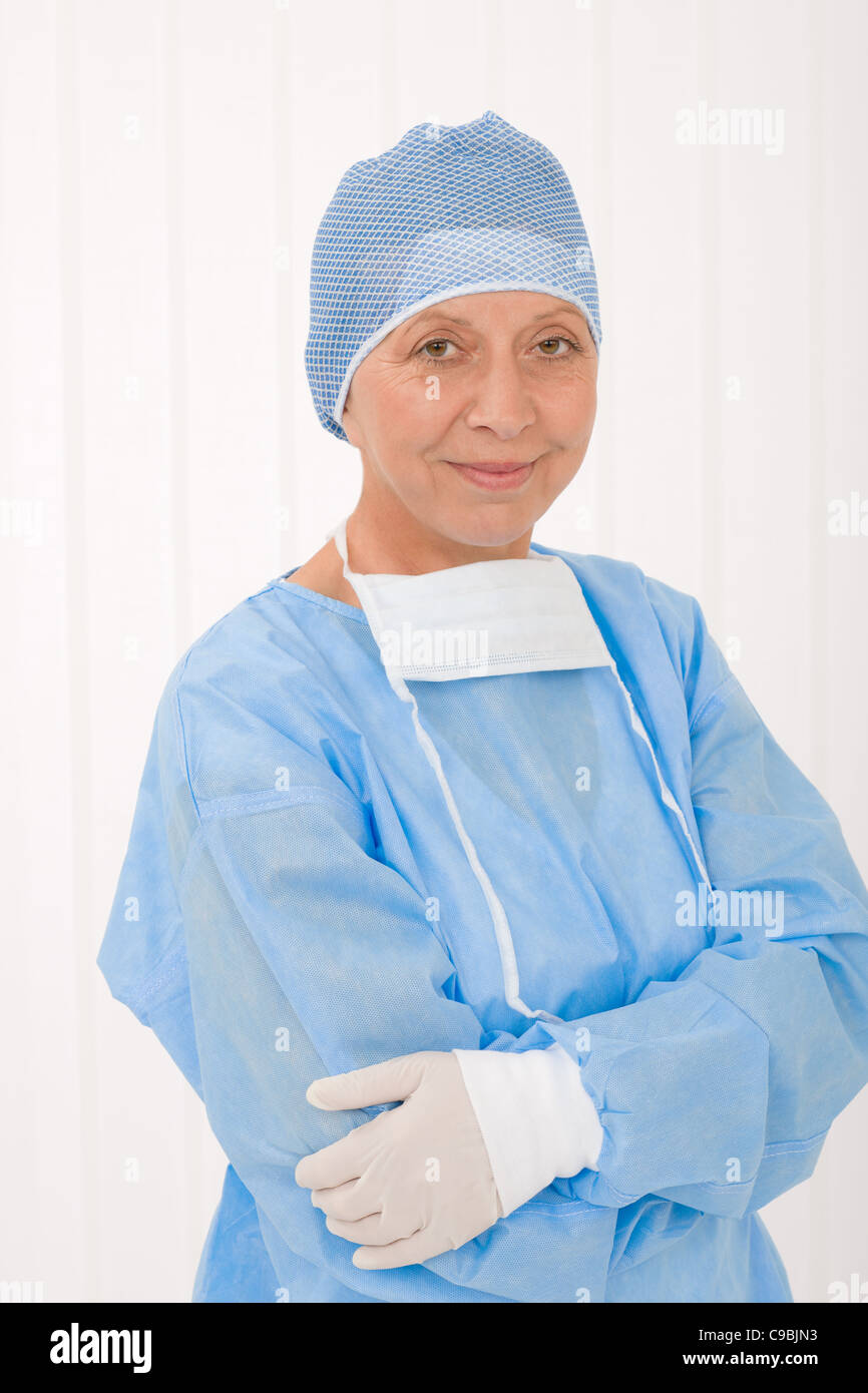 Senior surgeon female in protective operation overall uniform and mask ...