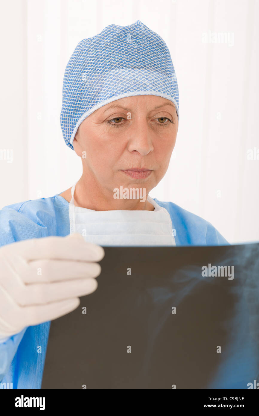 Senior surgeon female in protective operation overall uniform and mask ...