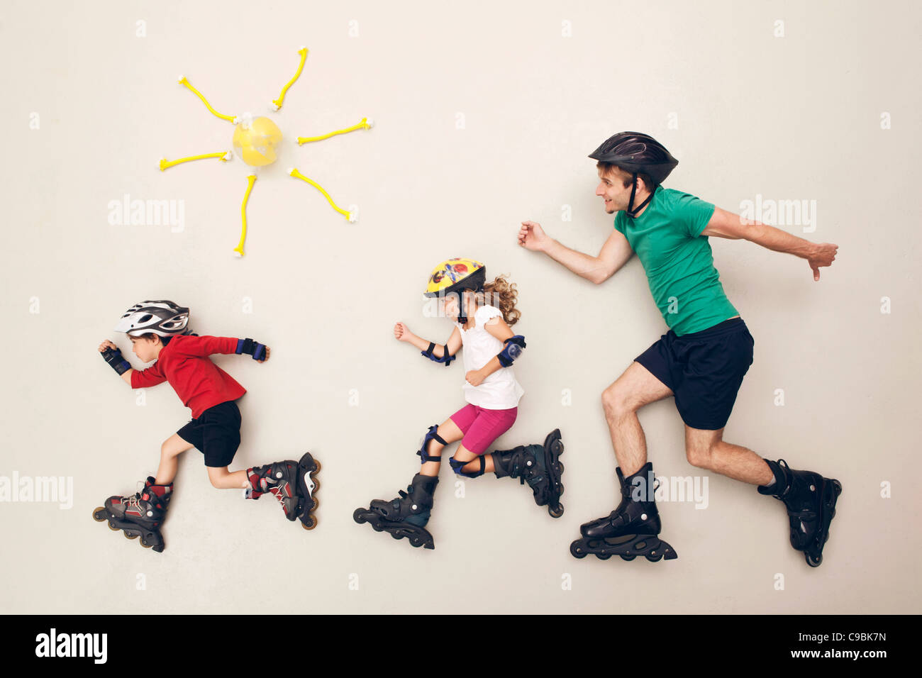 Germany, Artificial scene with family doing inline skating Stock Photo ...