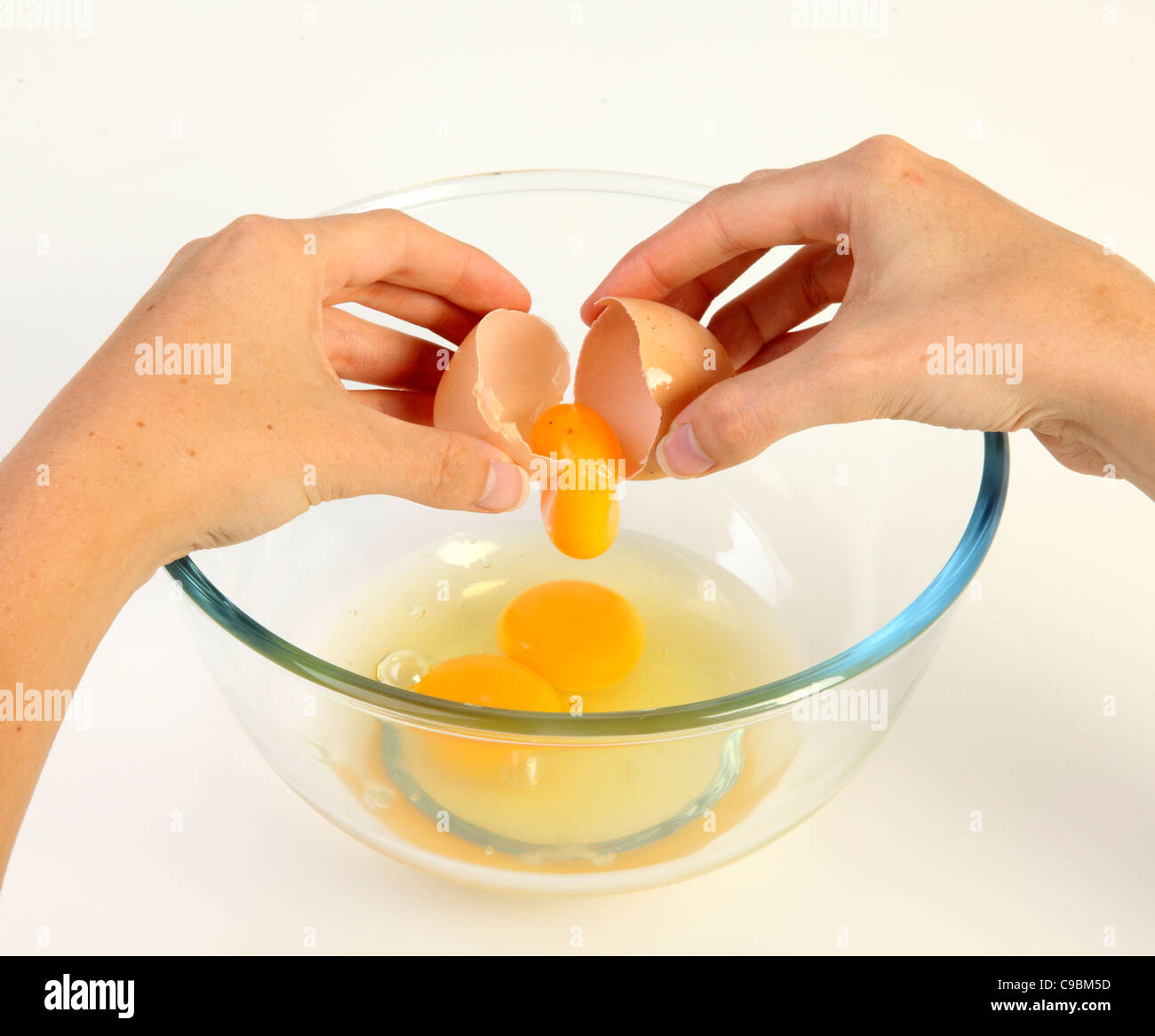 CRACKING AN EGG Stock Photo - Alamy