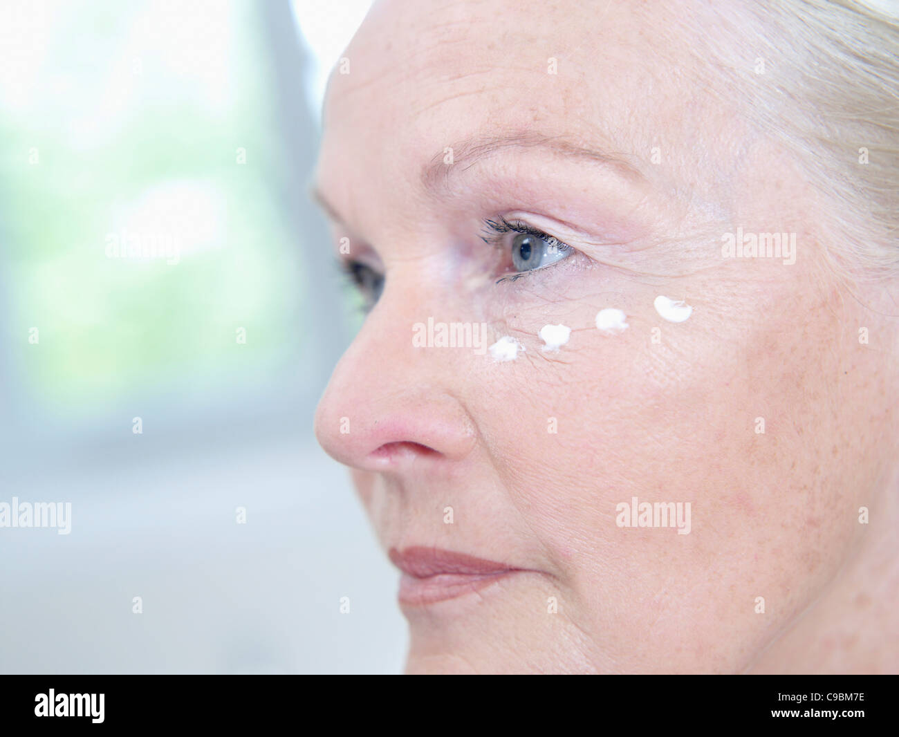 Senior woman with face cream on face, close up Stock Photo - Alamy