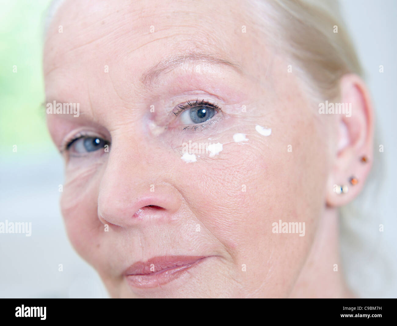 Senior woman with face cream on face, portrait Stock Photo - Alamy